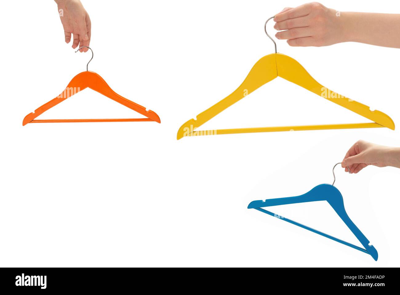 Yellow hanger in woman hand isolated on white background Stock Photo ...