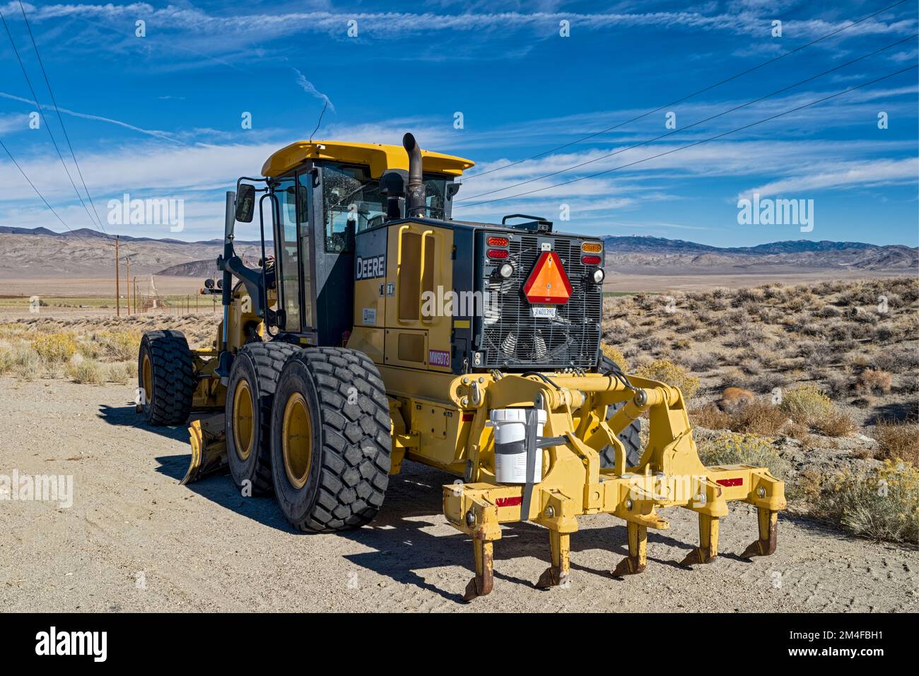 A John Deere 872G Motor Grader parked on the side of the road near Big ...