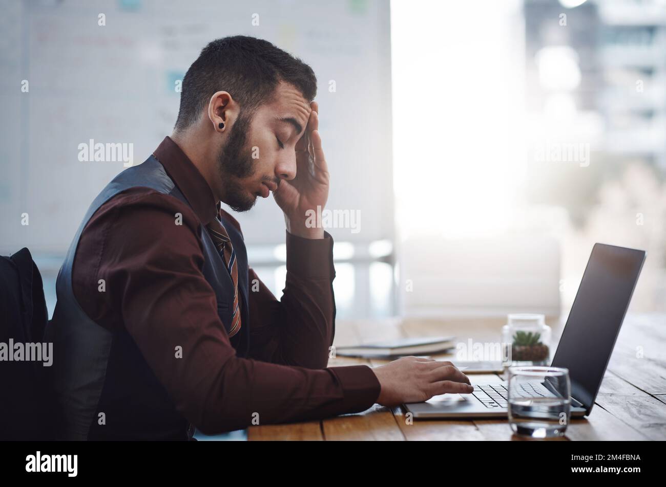 These deadlines are turning into a real headache. a young businessman ...