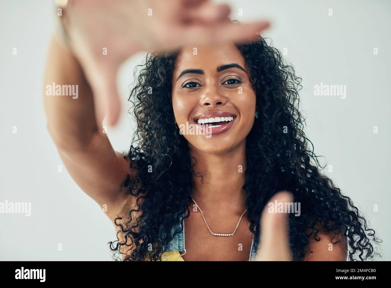 This makes for a great angle. Studio shot of an attractive young woman ...