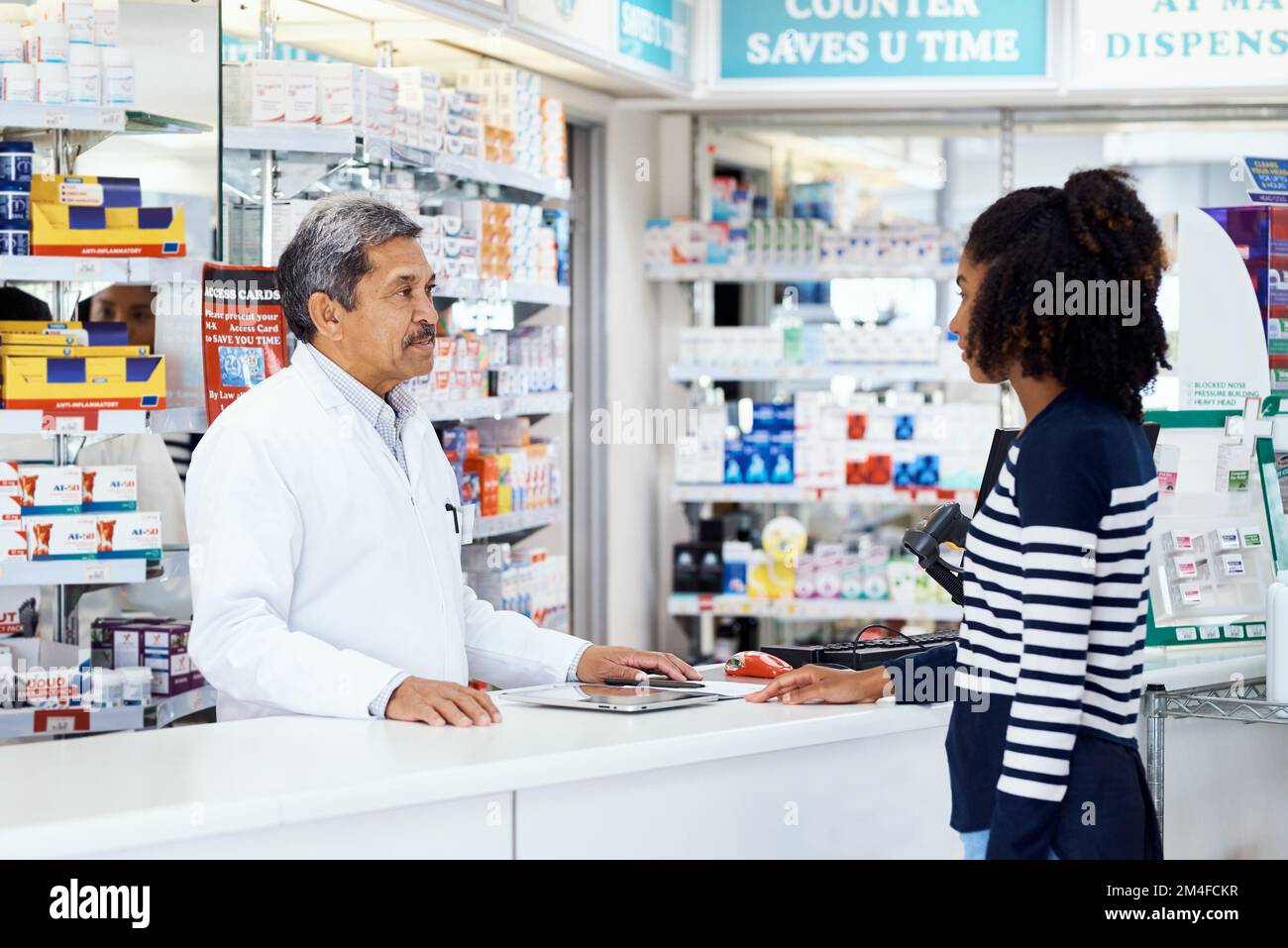 Get the correct meds with the right help. a pharmacist assisting a ...