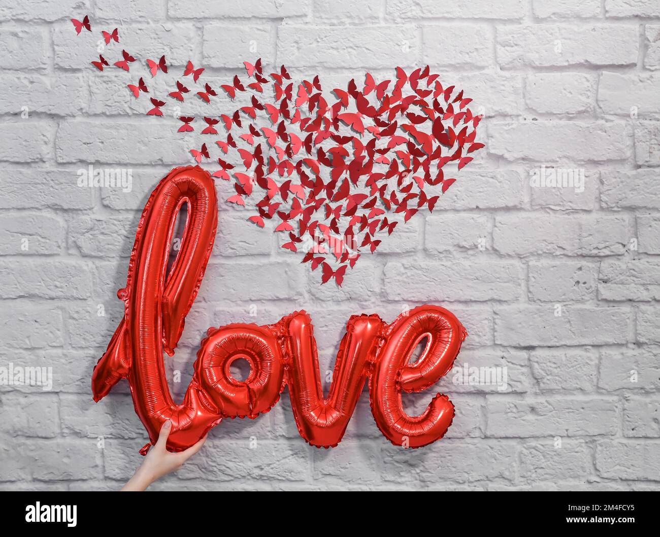a heart in the shape of butterflies. inflatable word love. against the ...