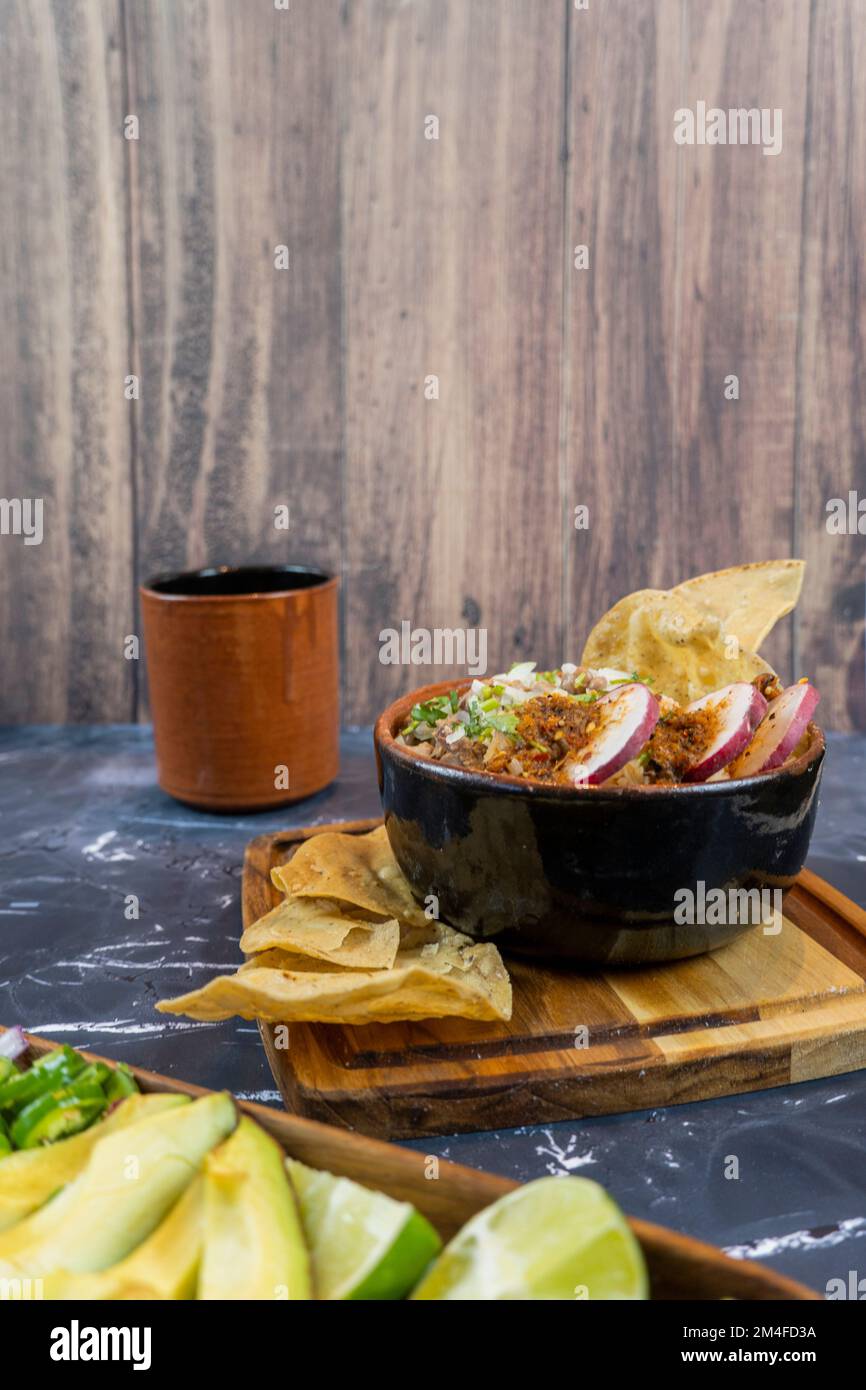lemons for meat dish in its juice with corn tortilla chips, glass with ...
