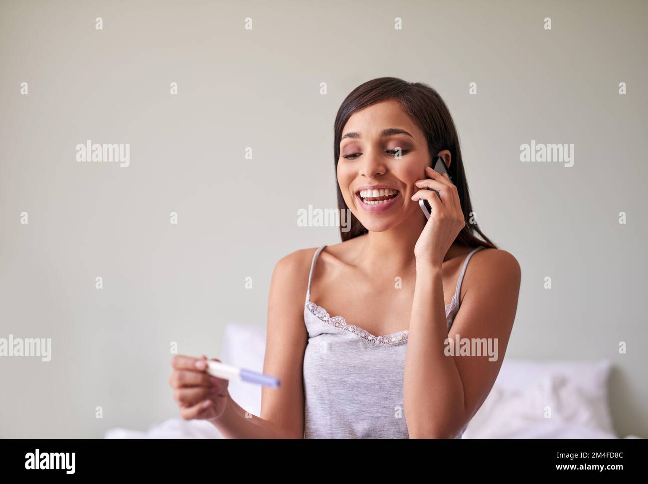 Spreading the good news. an attractive young woman taking a pregnancy ...