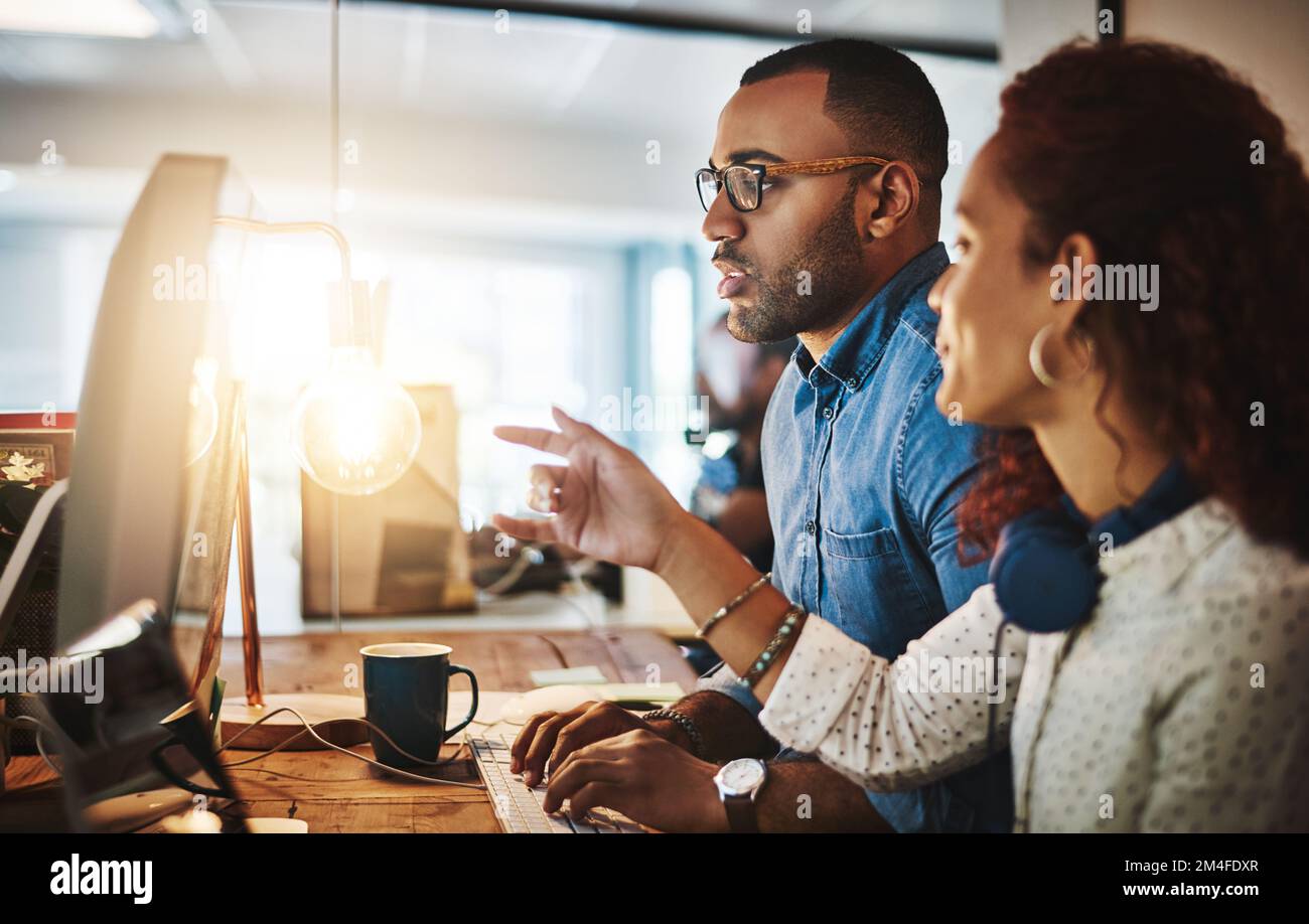 Completing their work task with teamwork. a young businessman and ...