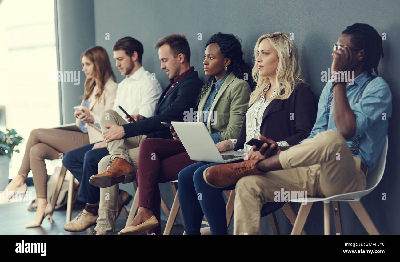 In the line for the interview. a group of businesspeople using ...