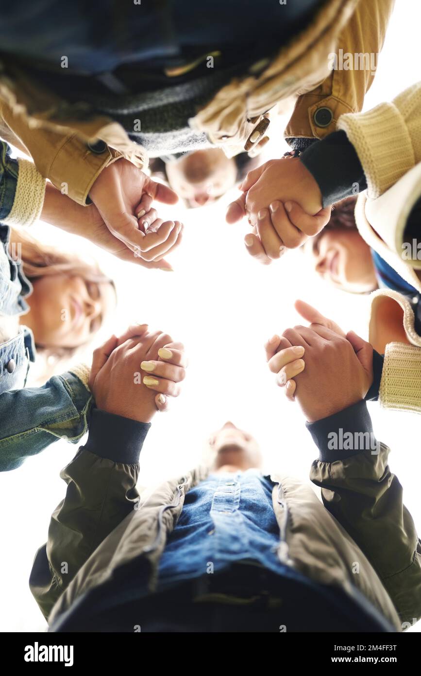 We have a strong bond. Low angle portrait of a group of young friends ...
