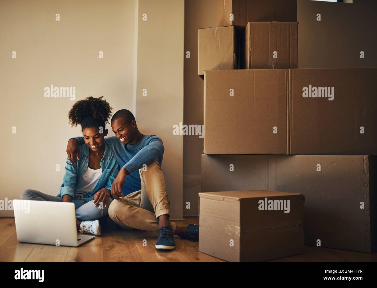 Shopping from our new home. a cheerful young couple browsing on a ...