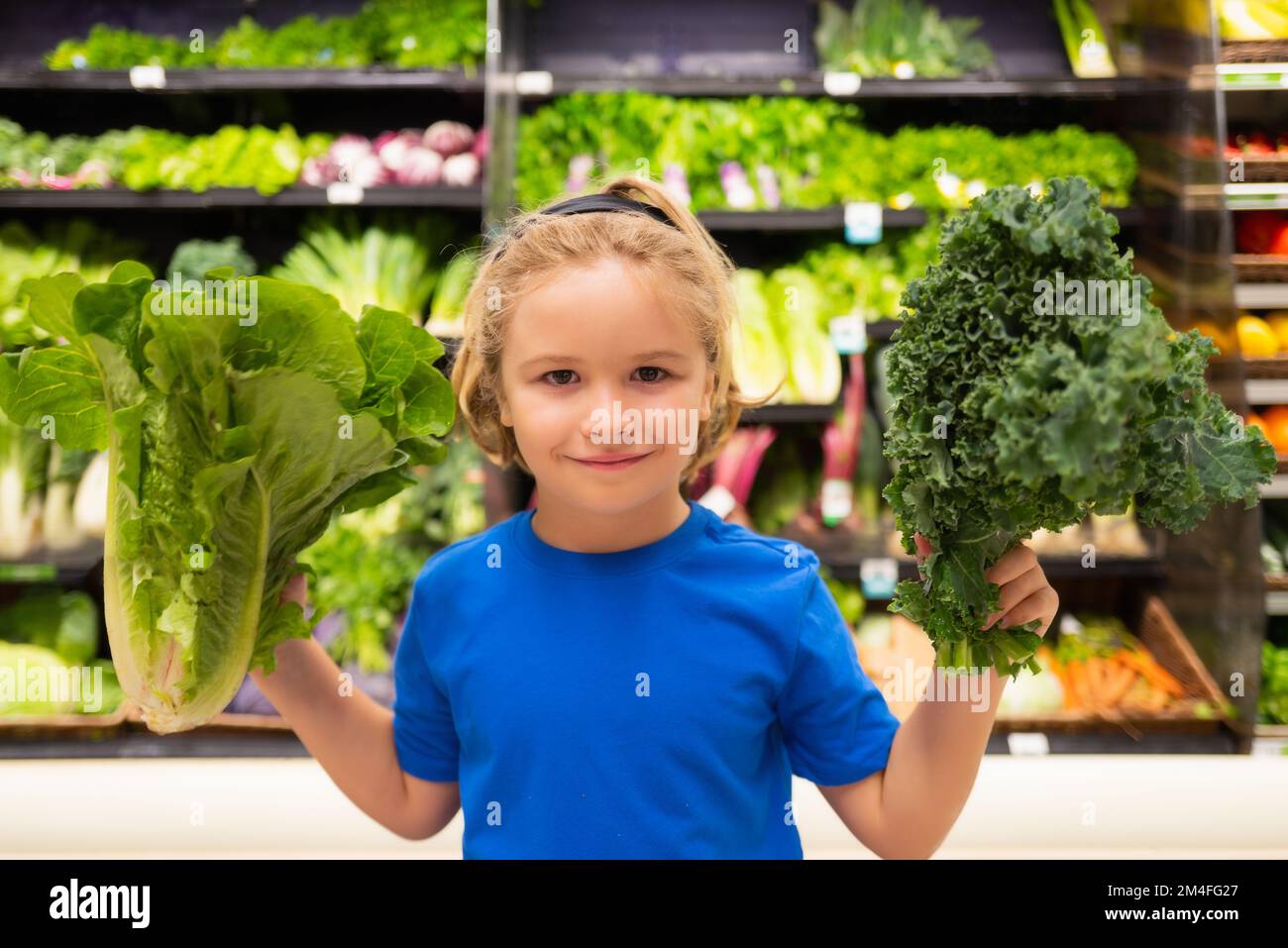 Kid with vegetables at grocery store. Healthy food for kids. Portrait ...