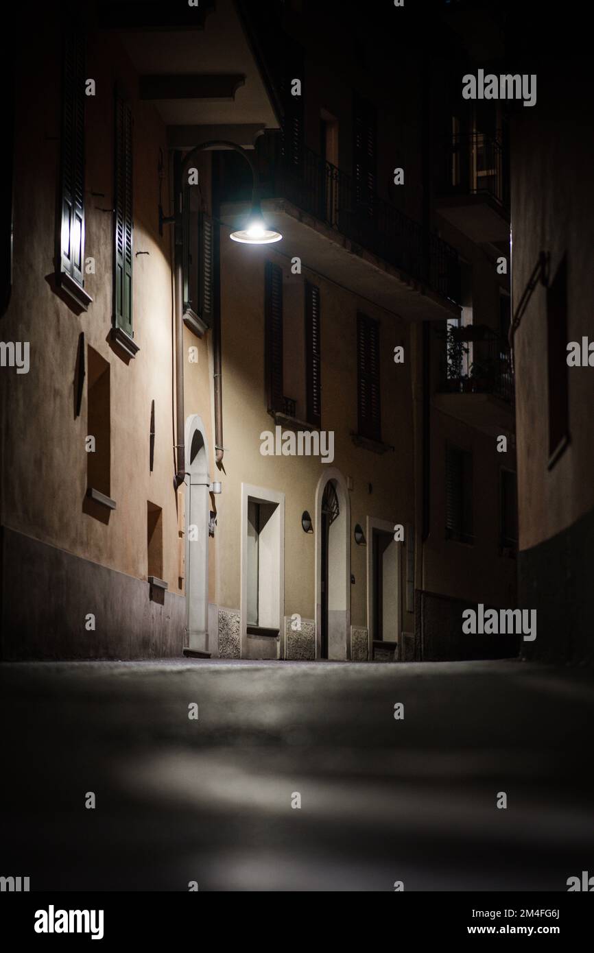 A city street with an illuminated house building at night Stock Photo ...
