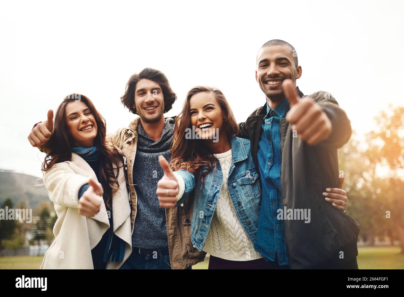 Nothing gets us down. Portrait of a group of cheerful young friends ...