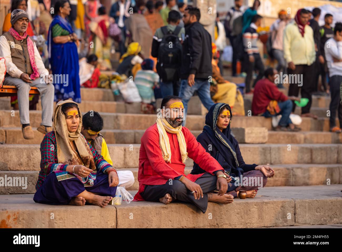 Varanasi, India - November 2022: Tourists performing rituals along with ...