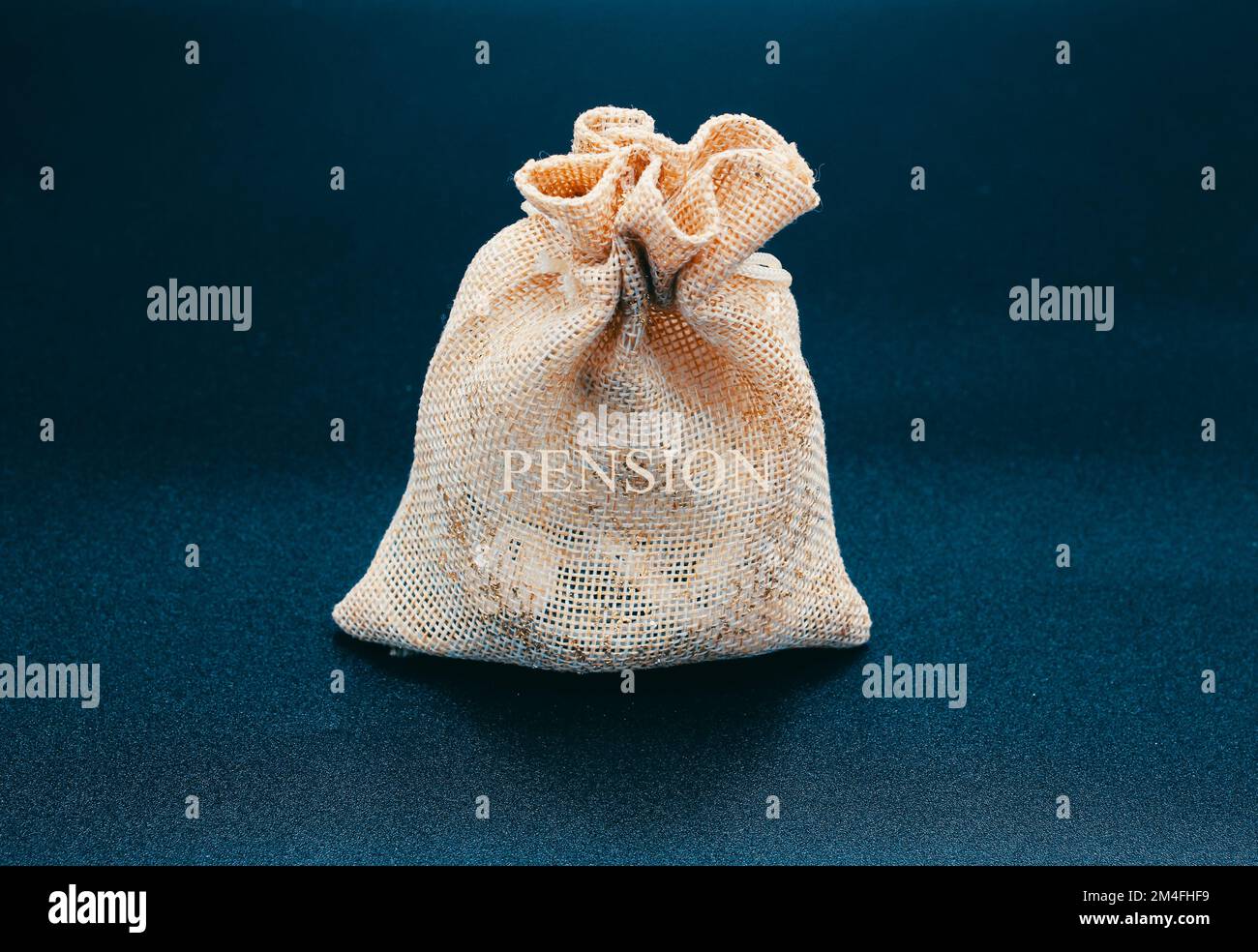 Retirement saving and pension planning money in burlap sack bag background with copy space Stock ...