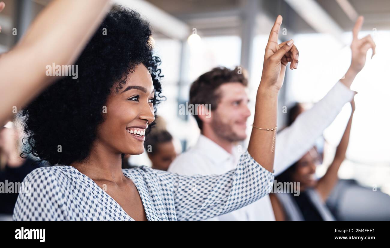 Count us in. a group of businesspeople raising their hands to ask ...