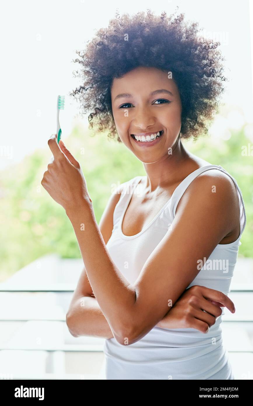 Never rush when you have to brush your teeth. an attractive young woman ...