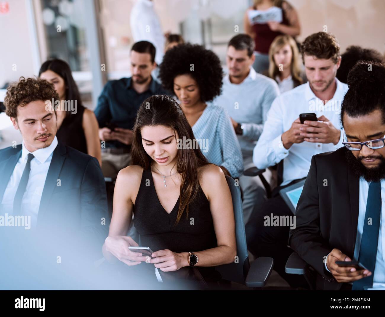 Turning off their phones before the presentation begins. a group of ...