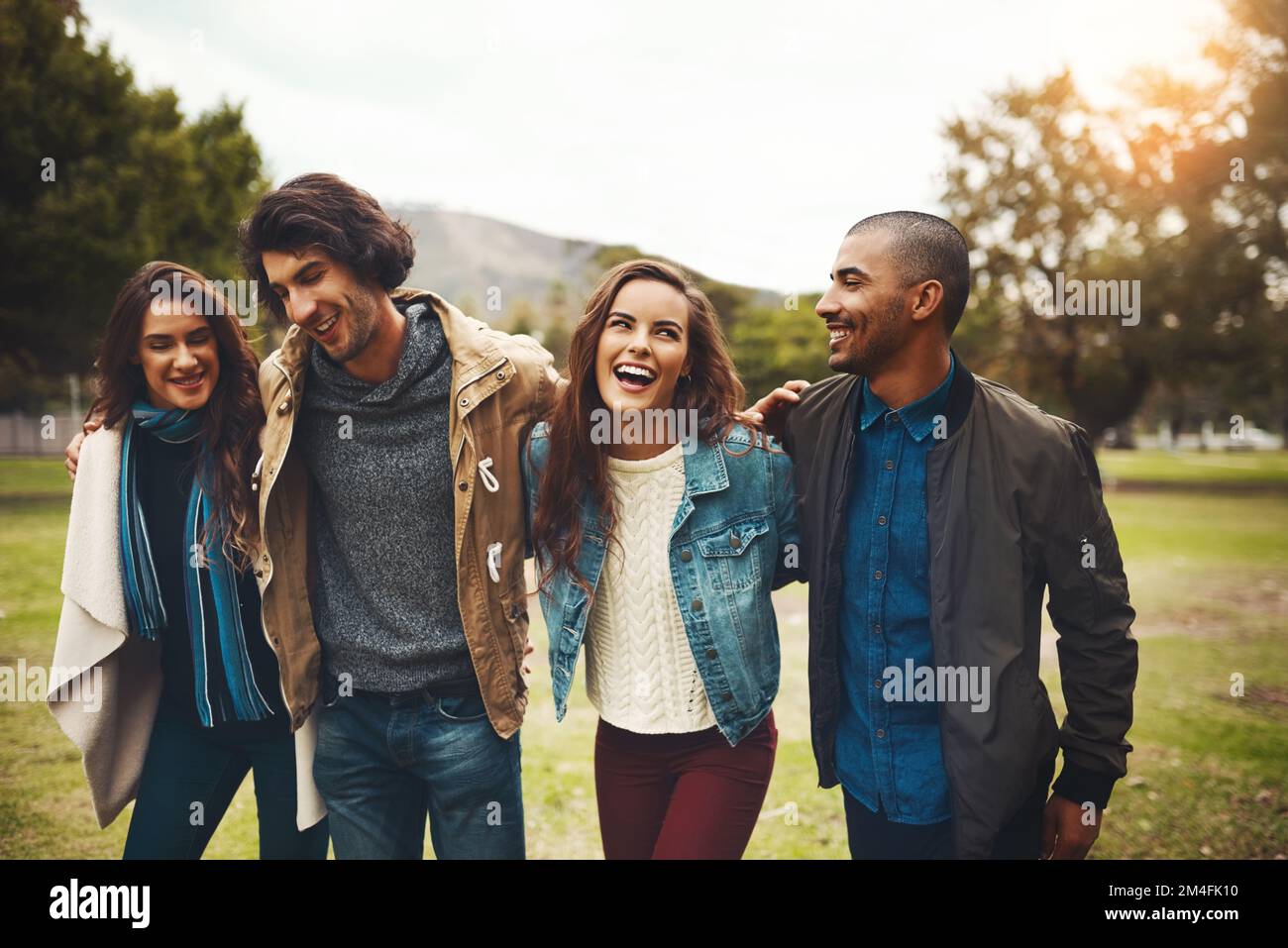 Lets do this together. a group of cheerful young friends huddled ...
