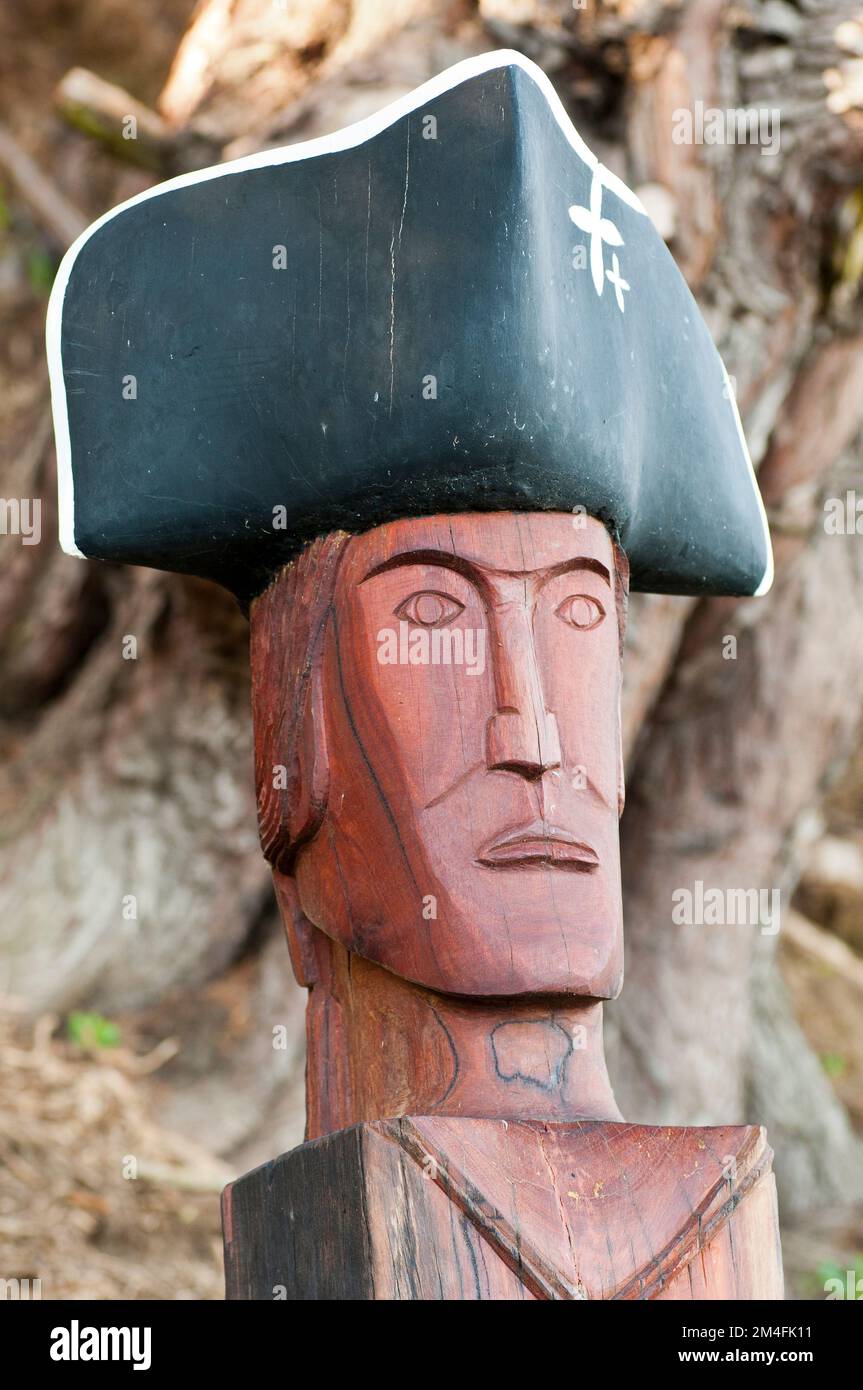 A sailor timber carvings by Nathan Rei alongside a pathway just above ...
