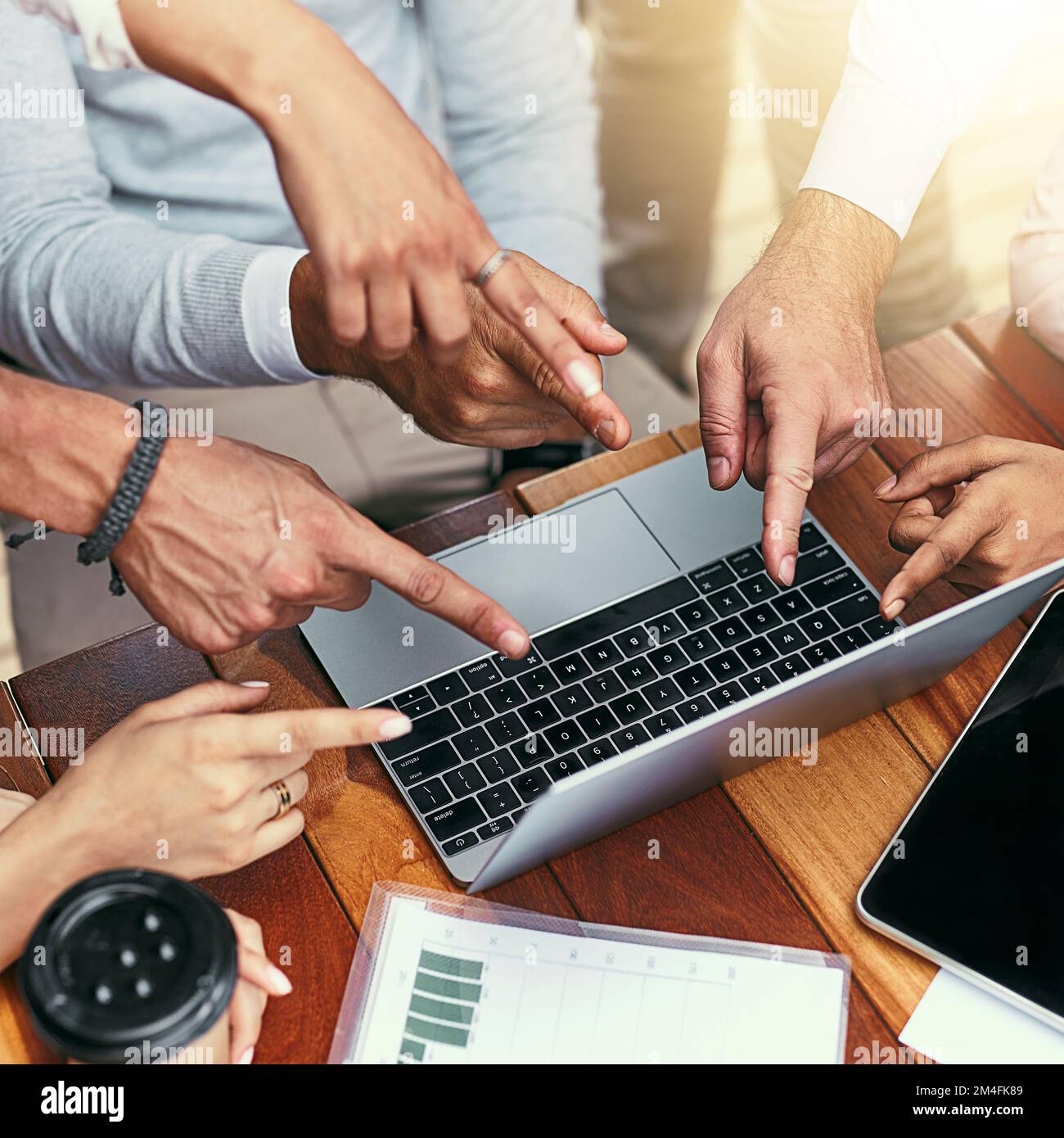 Productivity on point. a team of businesspeople pointing at a laptop ...