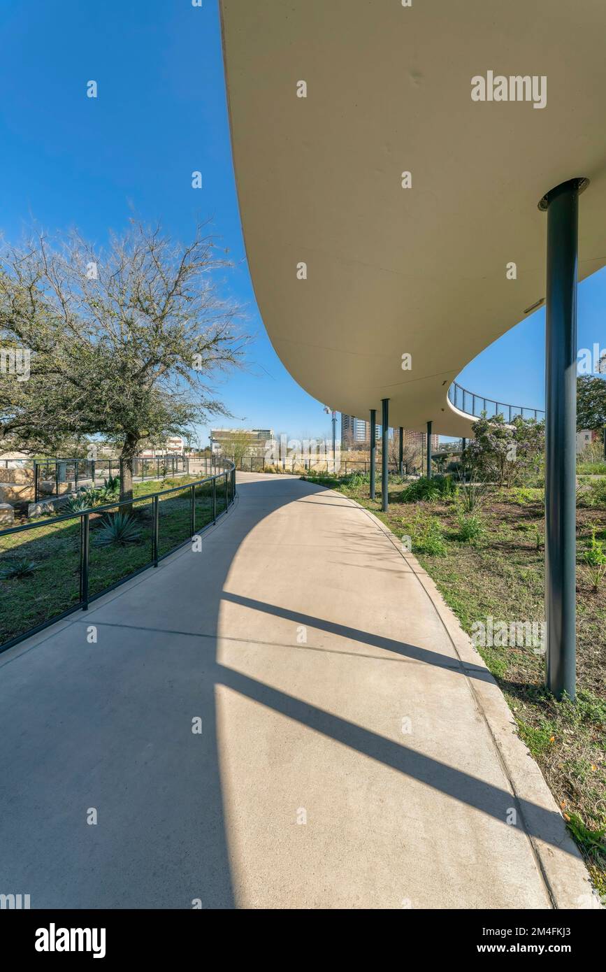 Austin, Texas- Walkway in he middle of green grassland under a bridge ...