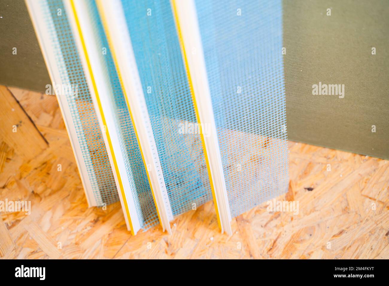 PVC profile near the window with a cuff and with a blue mesh close-up ...