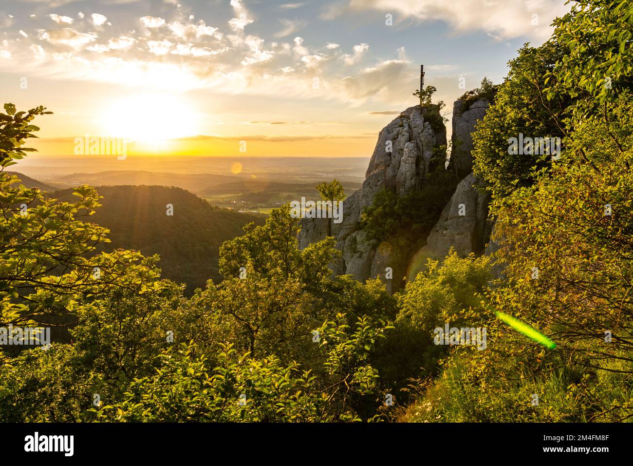 Beautiful sunset over rock ledge and forest in the Swabian Alps in ...