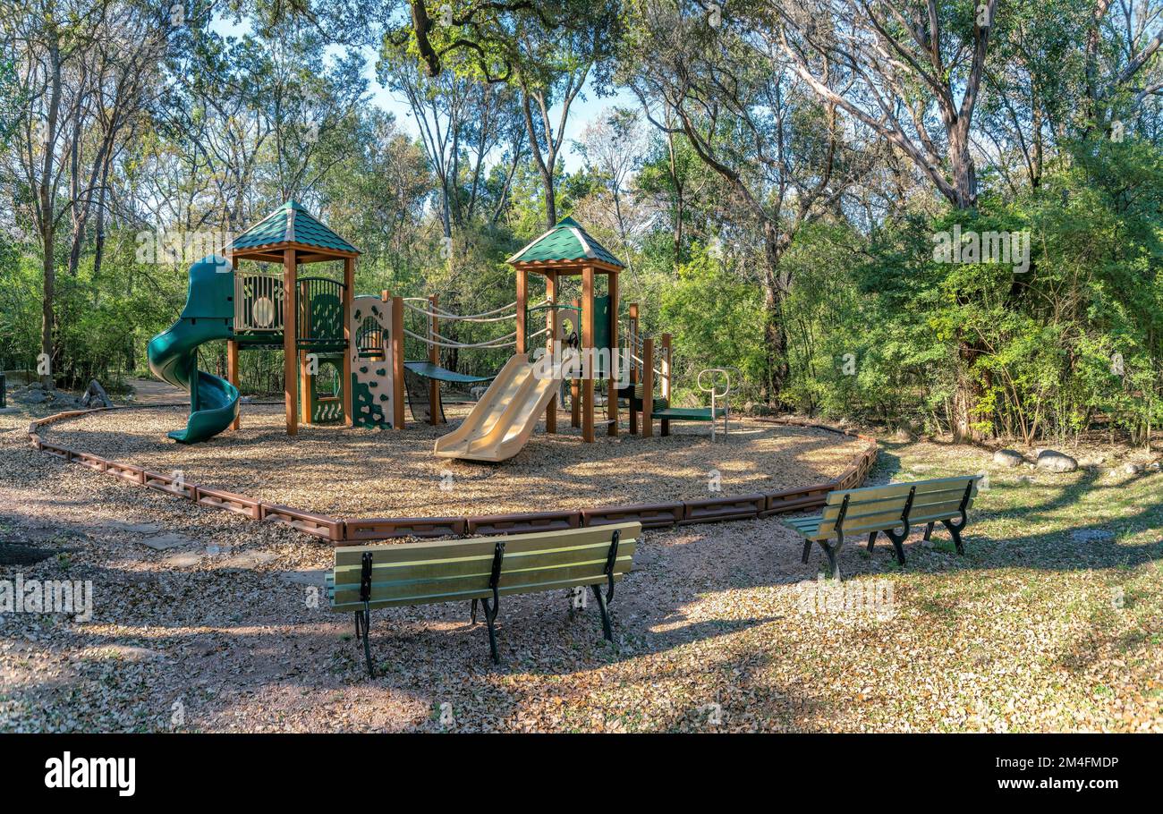 Austin, Texas- Community park with bench seats near the playground ...