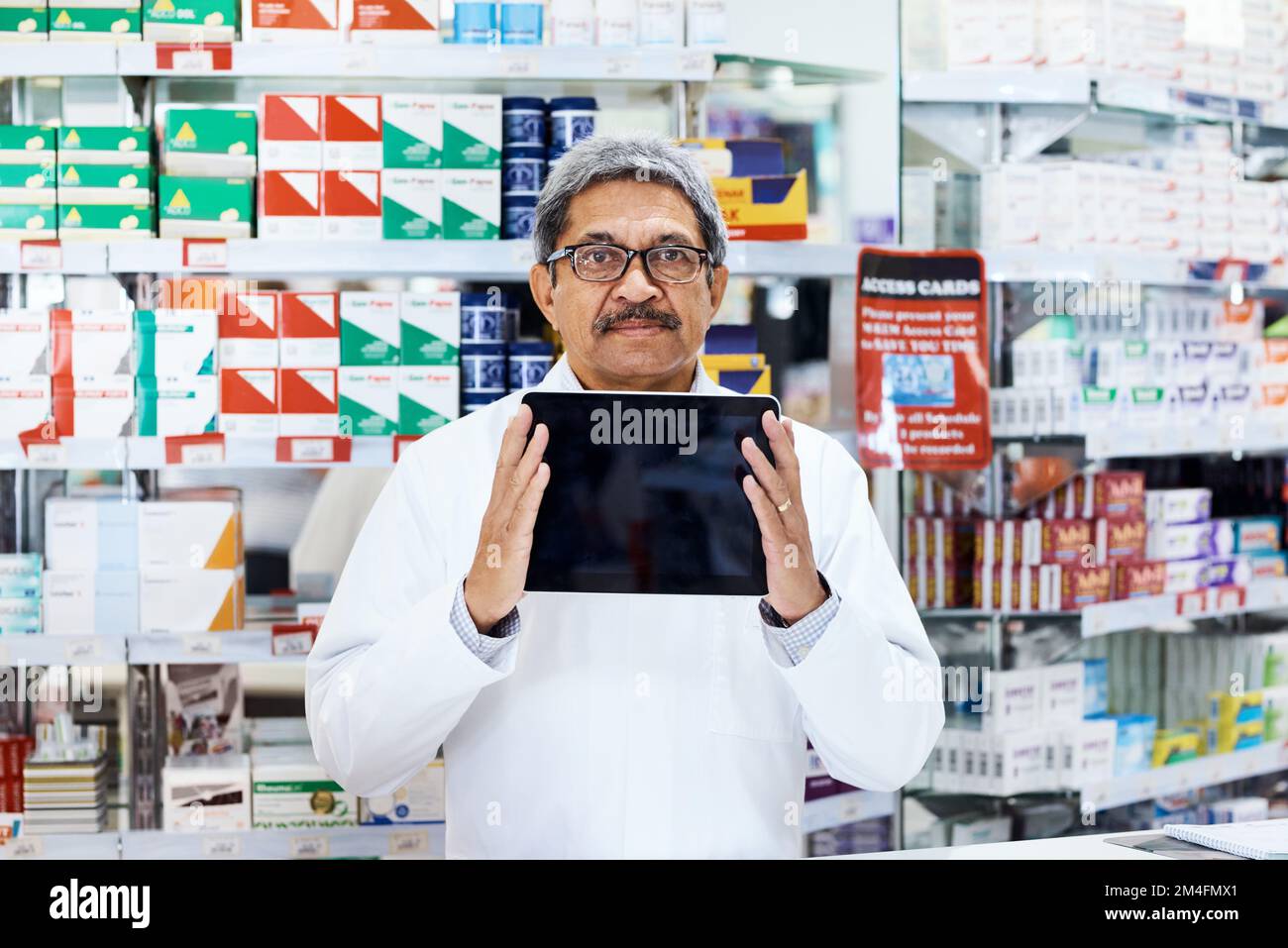 Heres my top recommendation. Portrait of a mature pharmacist holding up ...