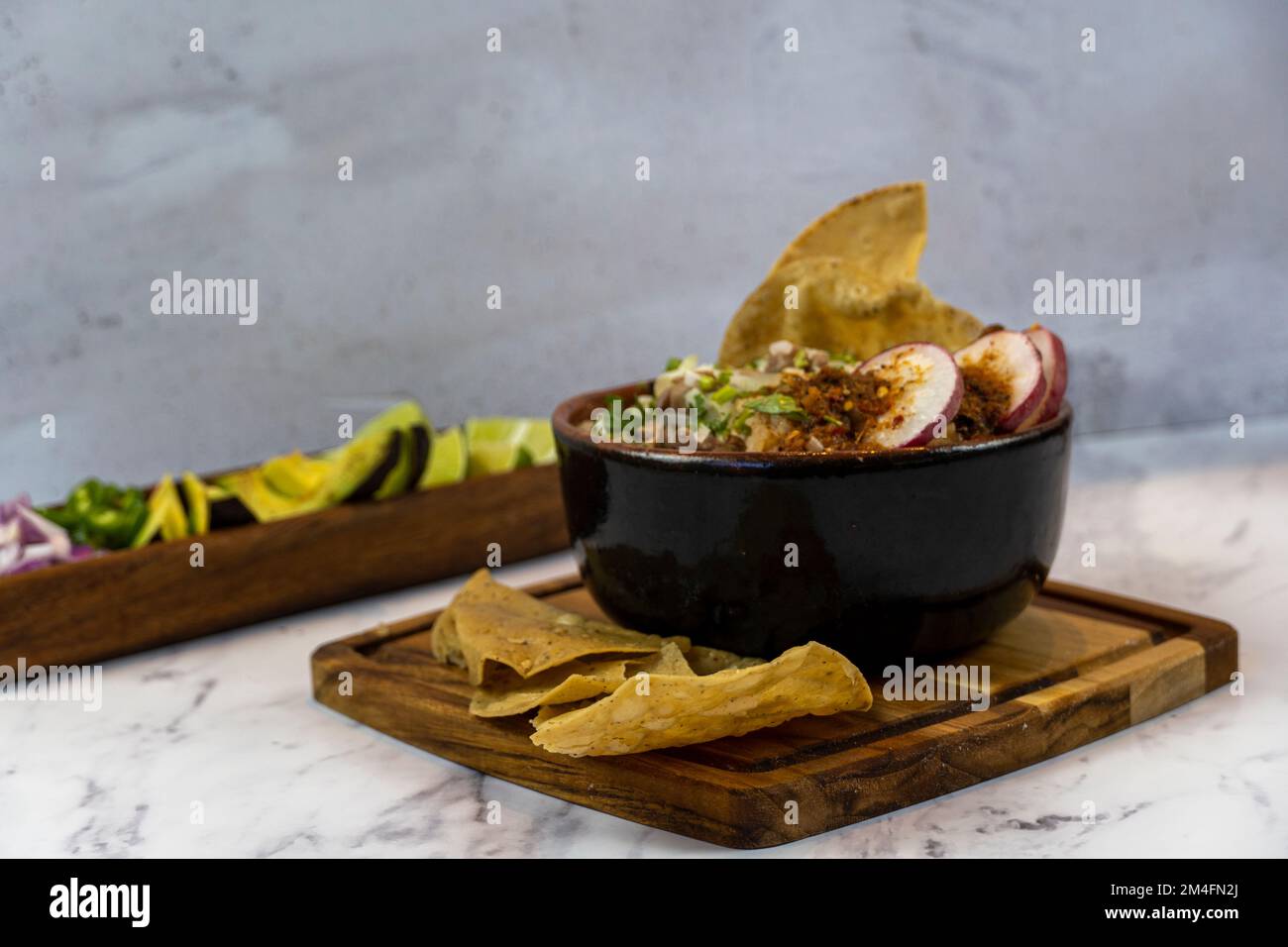 mexican meat dish with avocado and lemon, meat in its juice typical ...