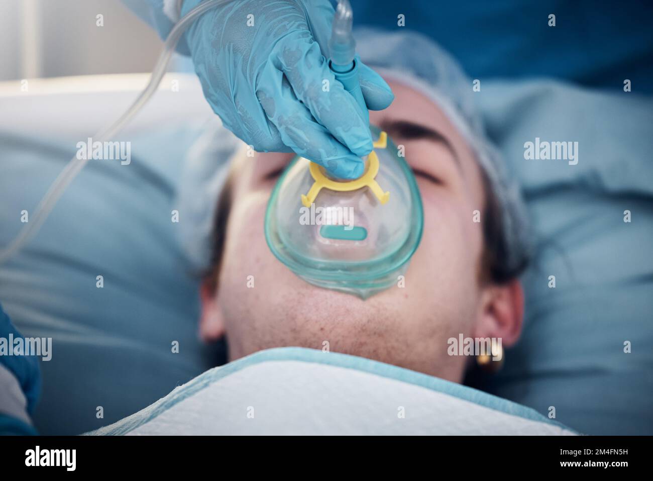 Anesthesia, oxygen mask and medical with man in surgery for breathing ...
