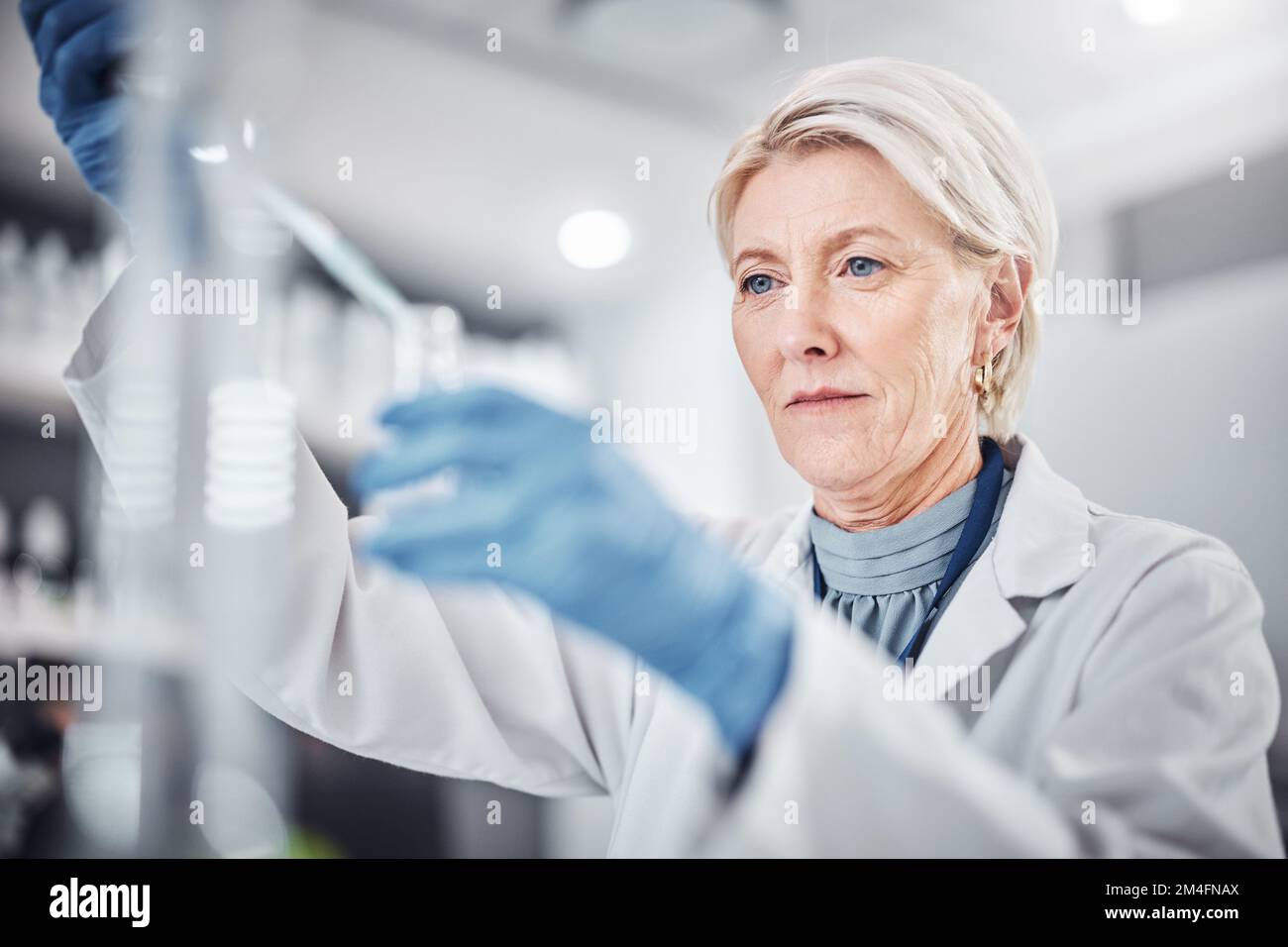 Senior woman, science beaker and pipette in laboratory for medical ...