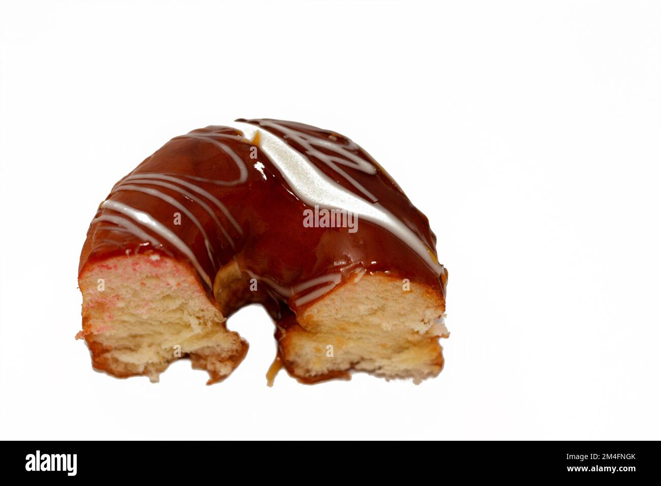 A ring donut topped with caramel and white chocolate sauce, A glazed ...