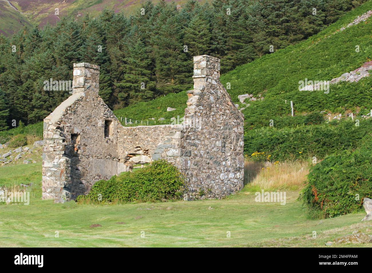 Ruin of an old cottage in the countryside. Stone walls and no roof ...