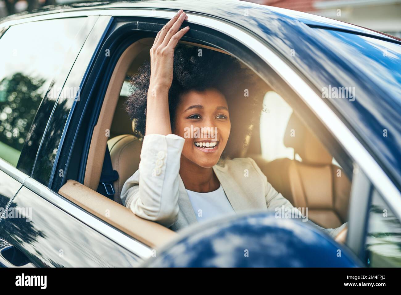 Finally we have movement. a cheerful young businesswoman driving in a ...