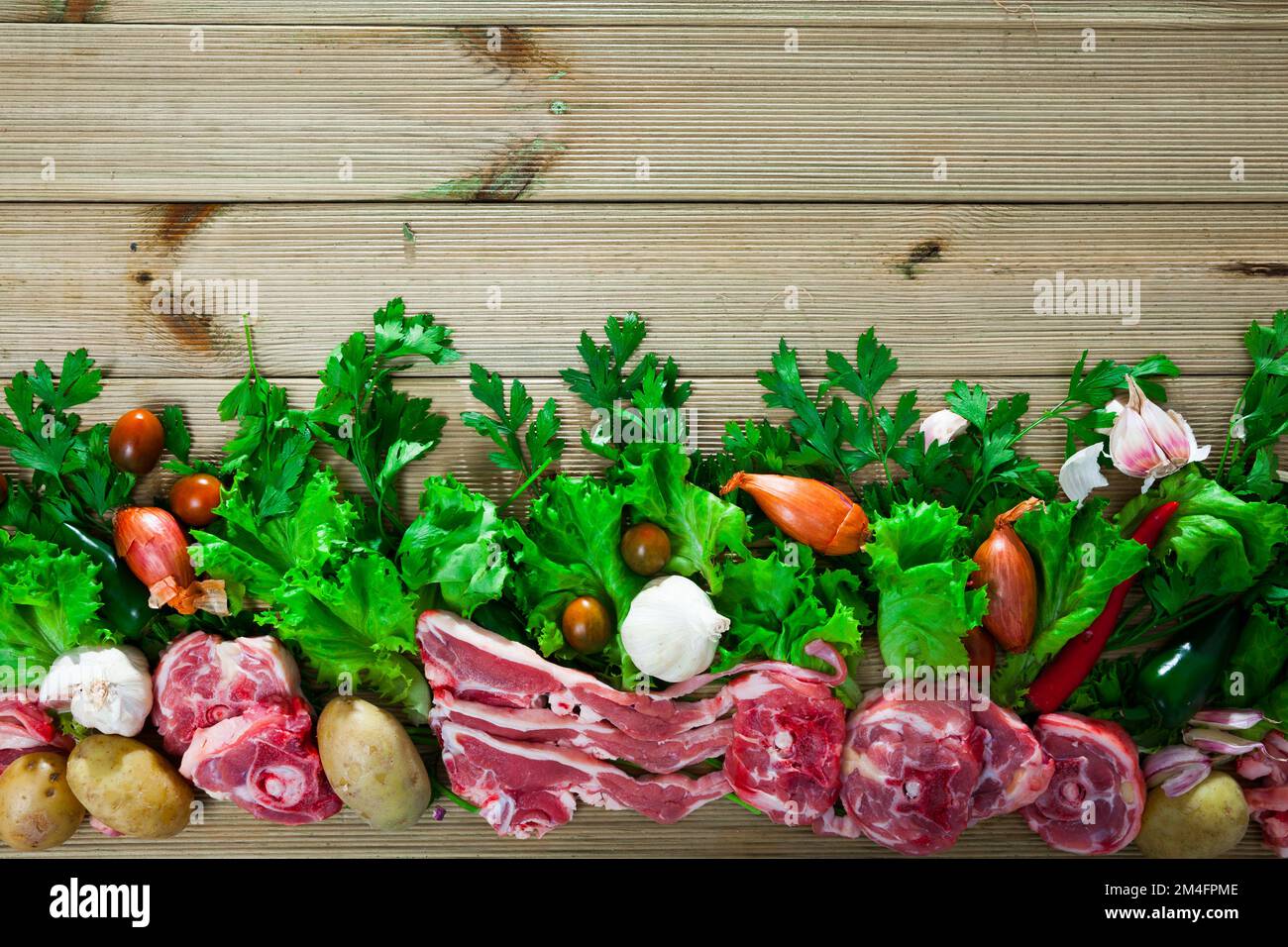 Natural border with lamb and greens Stock Photo - Alamy
