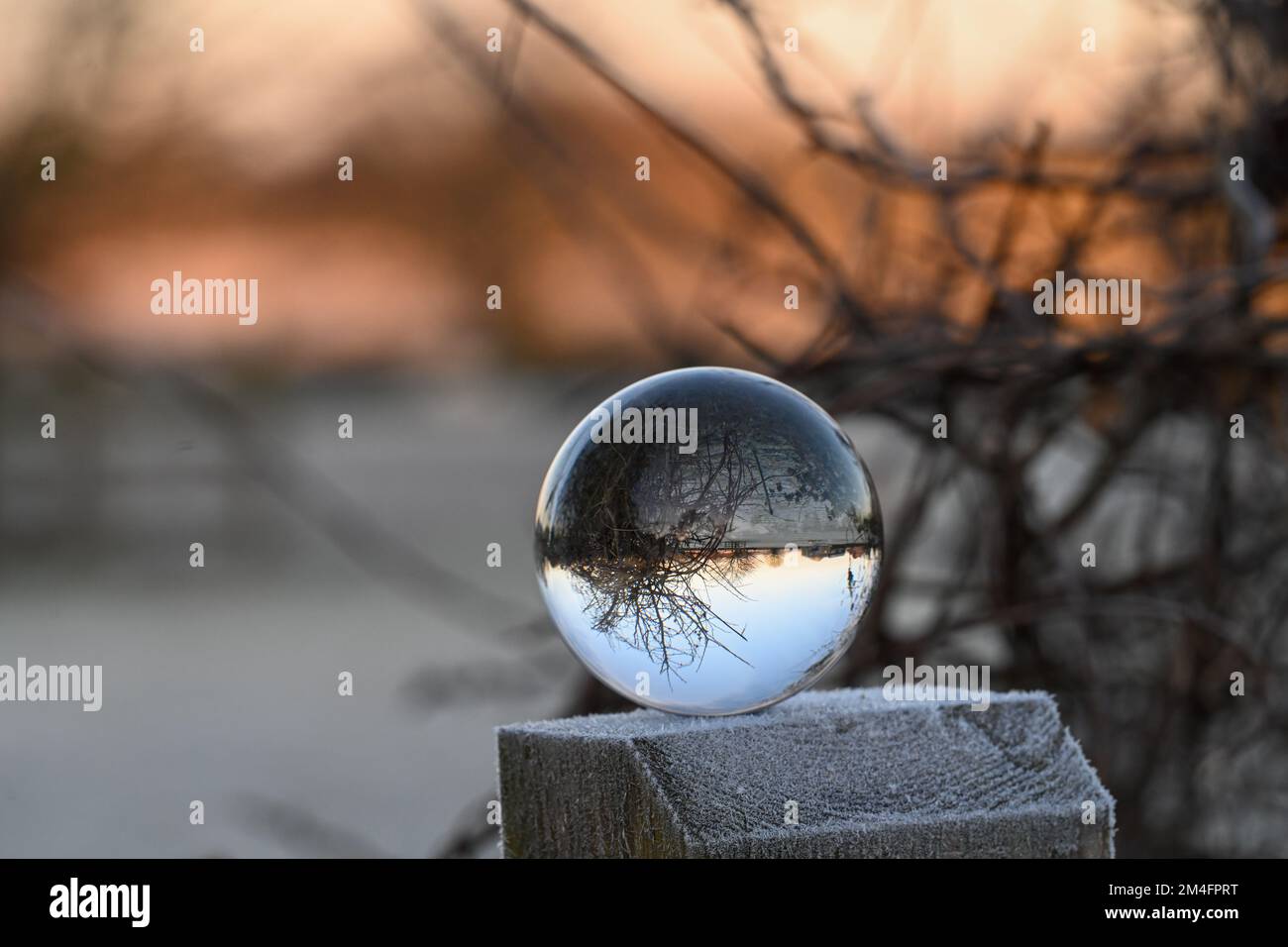 A crisp winters morning view through a clear crystal ball, an upside ...