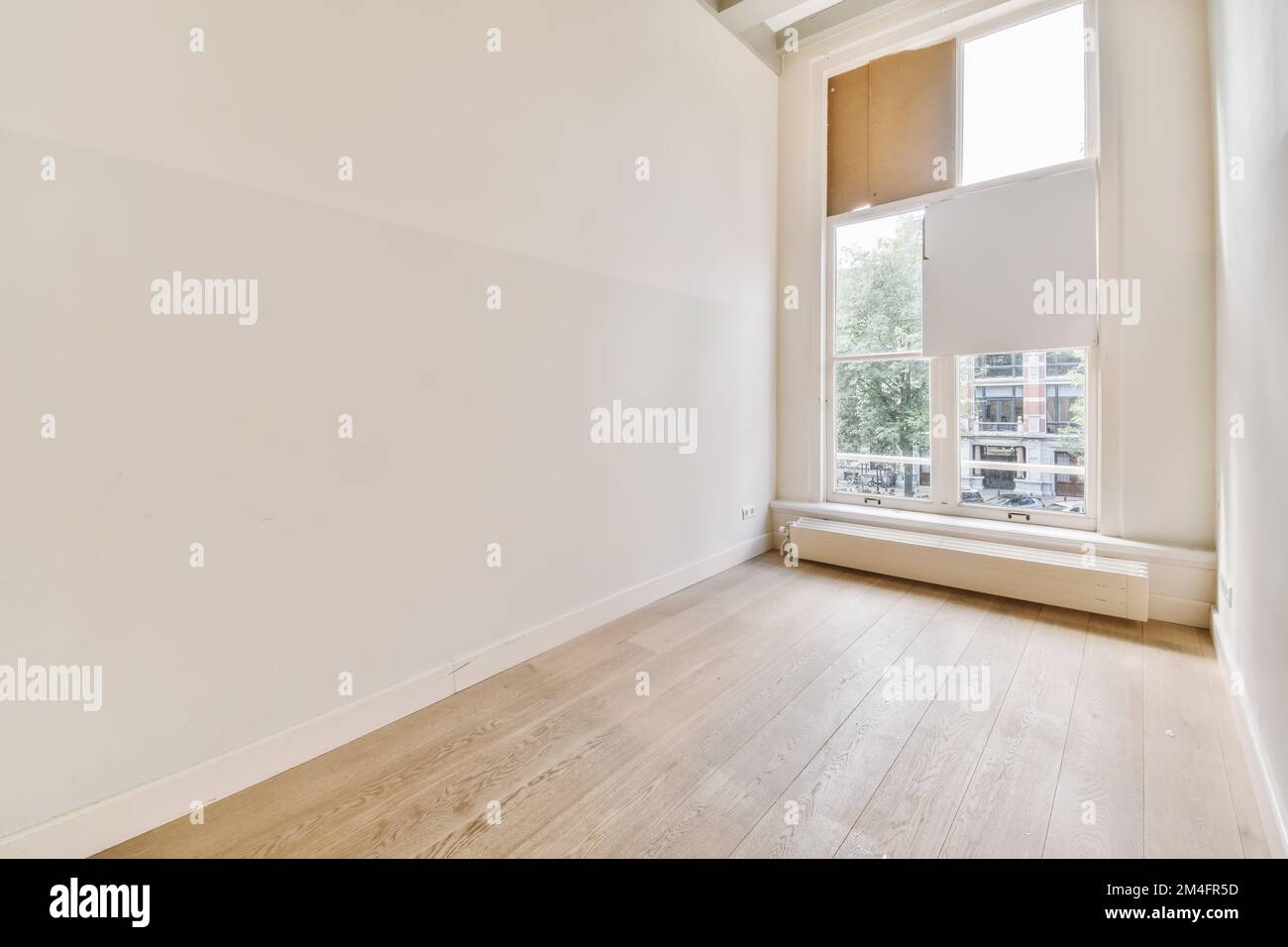 an empty room with white walls and wood flooring on the right side ...