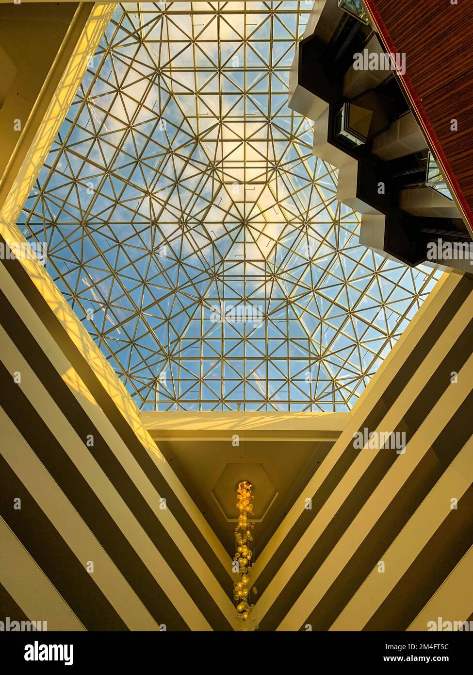 A vertical shot of a symmetrical pentagon-shaped ceiling with a cloudy ...