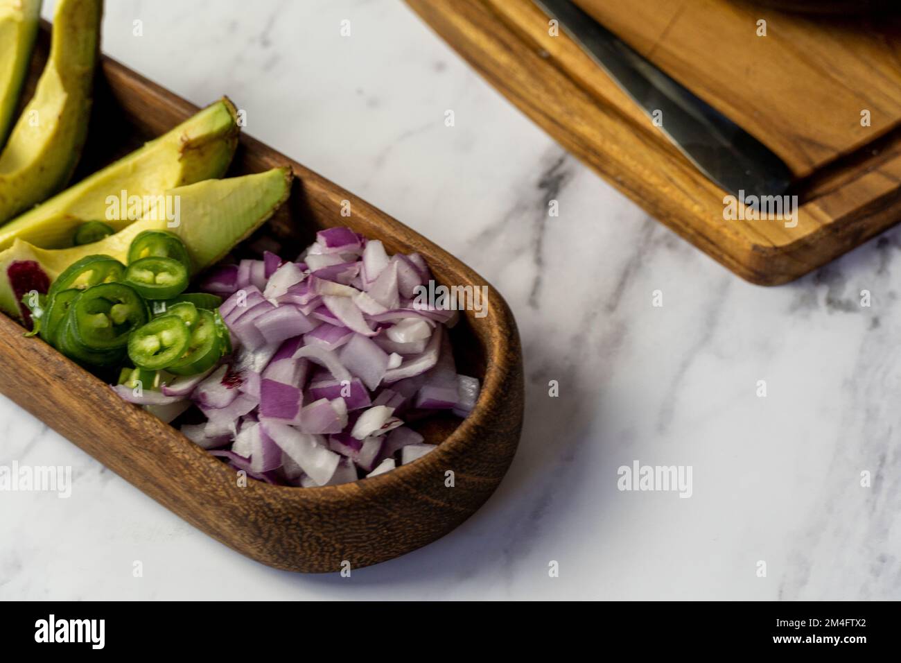 lemon and avocado on a wooden plate to put on meat, traditional mexican ...