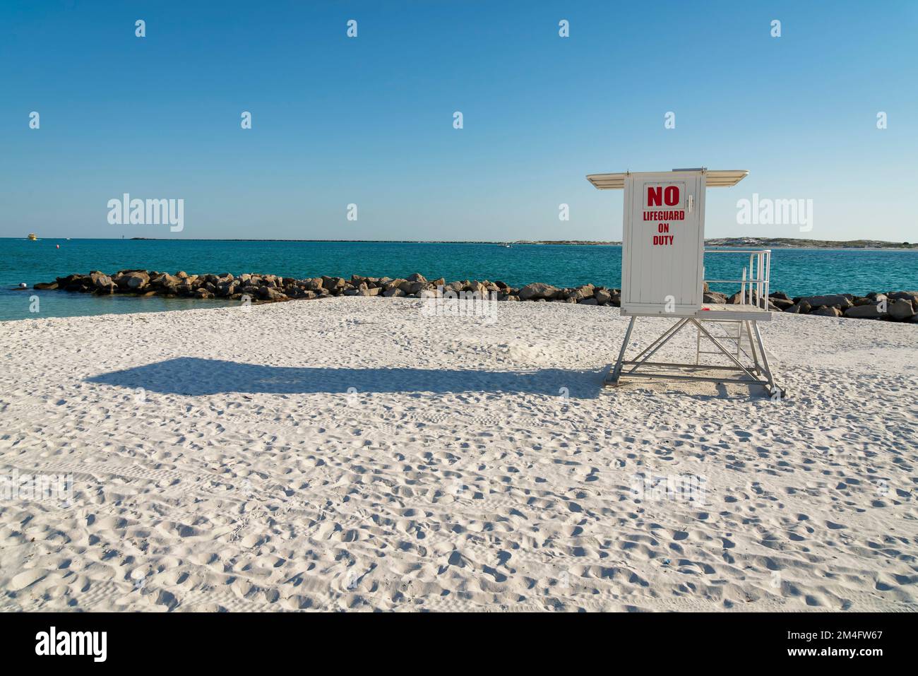 White lifeguard tower with painted red No Lifeguard On Duty lettering ...