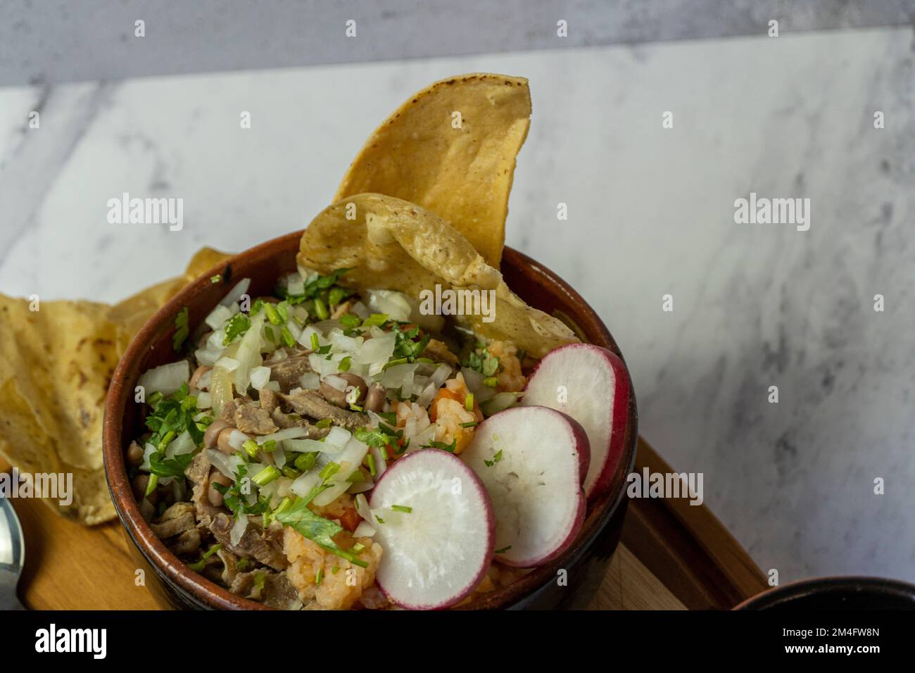 mexican meat dish with avocado and lemon, meat in its juice typical ...