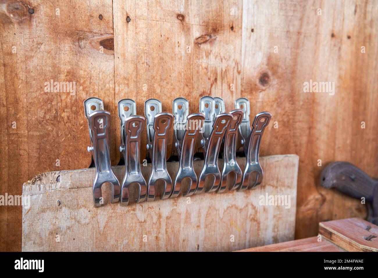 Closeup of a row of iron clips in a tool shed Stock Photo - Alamy
