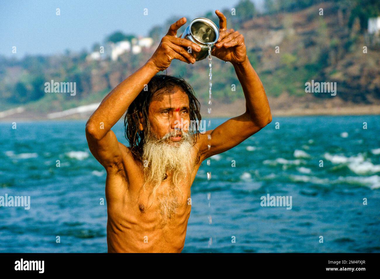 Pilgrim doing his washing and praying ceremony in the morning at the ...