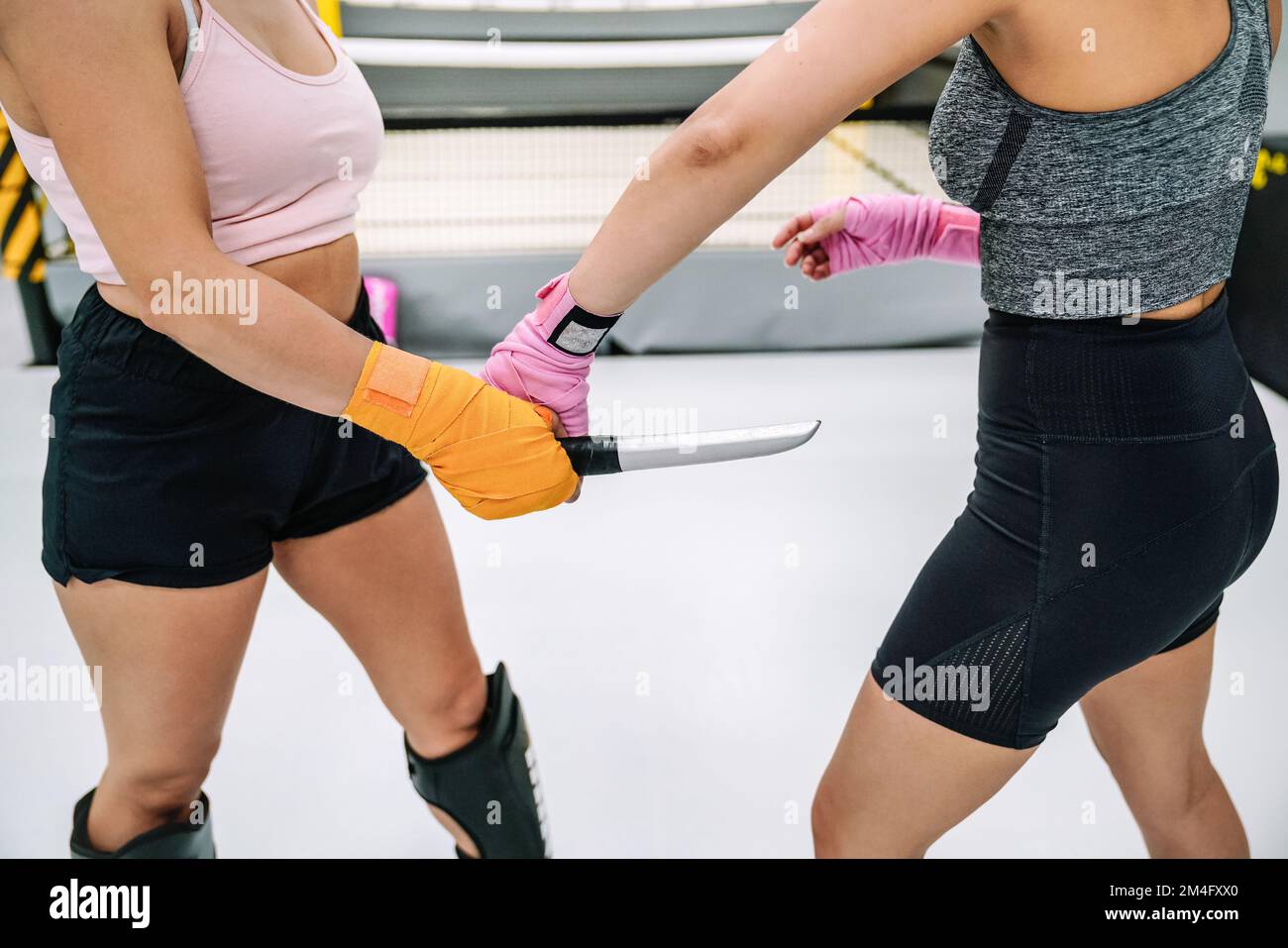 A woman performing a self-defense move to remove the knife from her ...