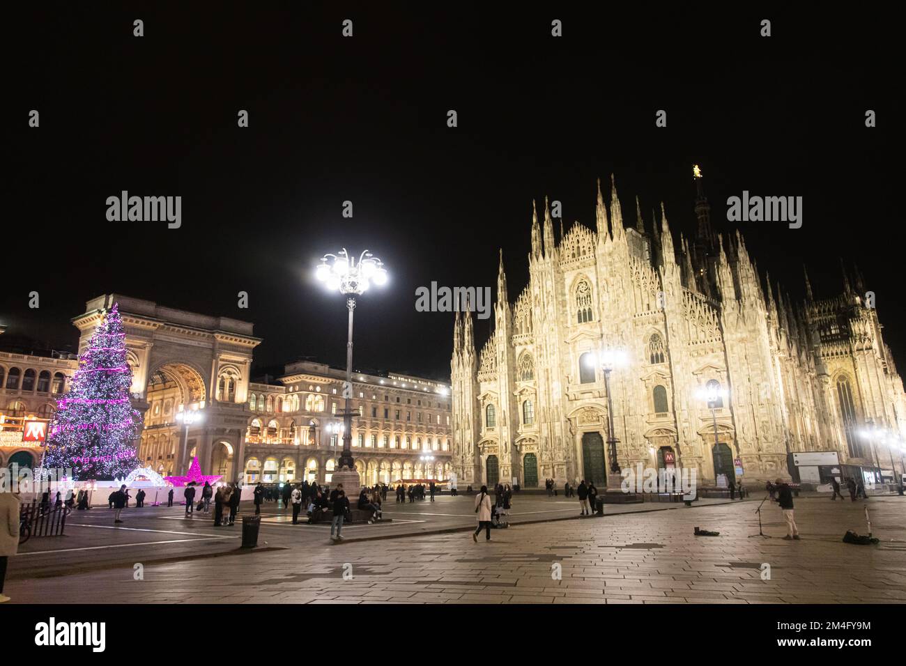 Milan, Italy - December 2022: wide angle street view of Piazza Duomo square at night with the ...
