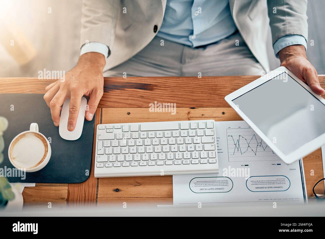 Never far from his workstation. High angle shot of an unrecognizable businessman working on a ...