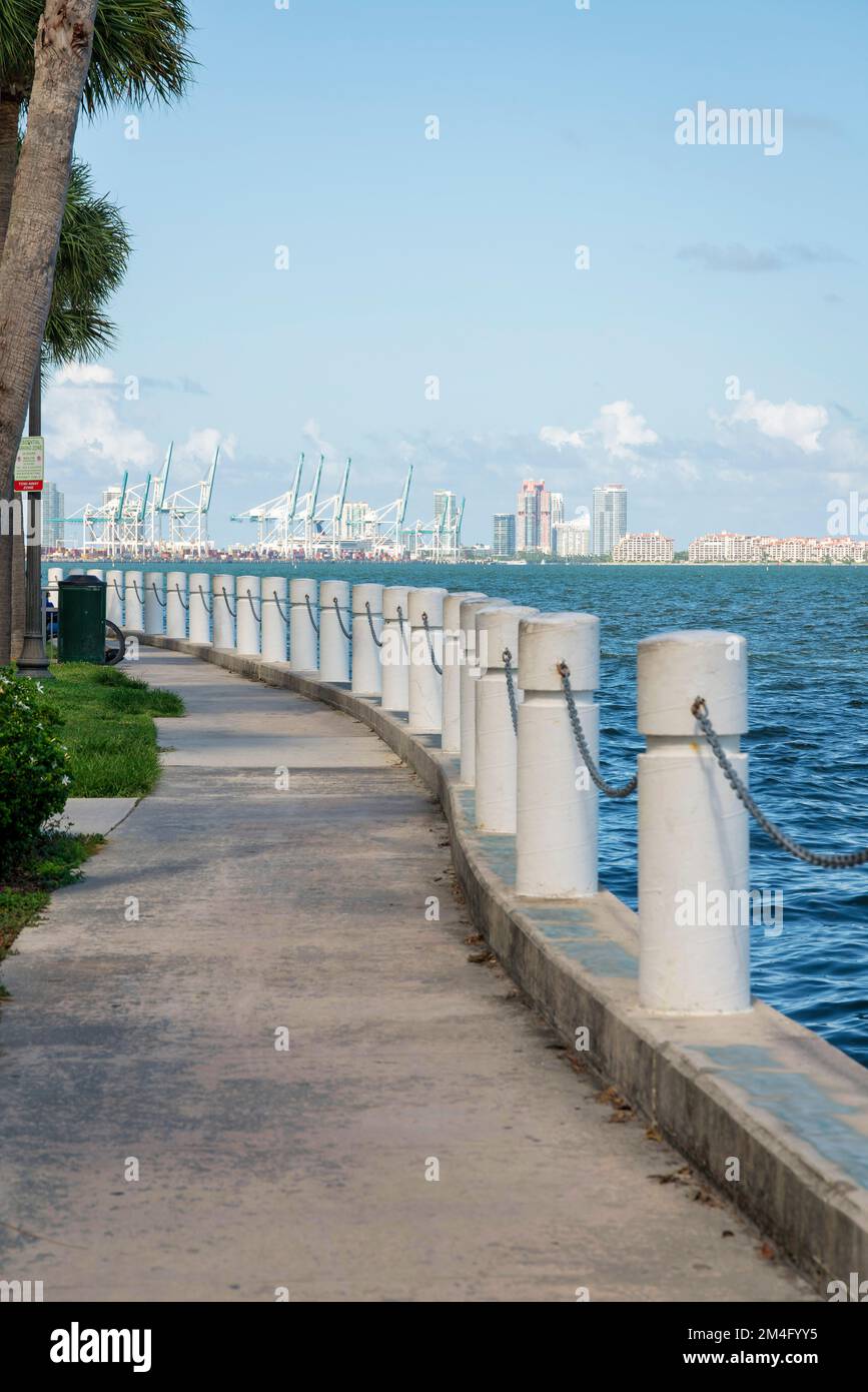 Pathway with concrete post and metal chains barrier near the ocean at ...
