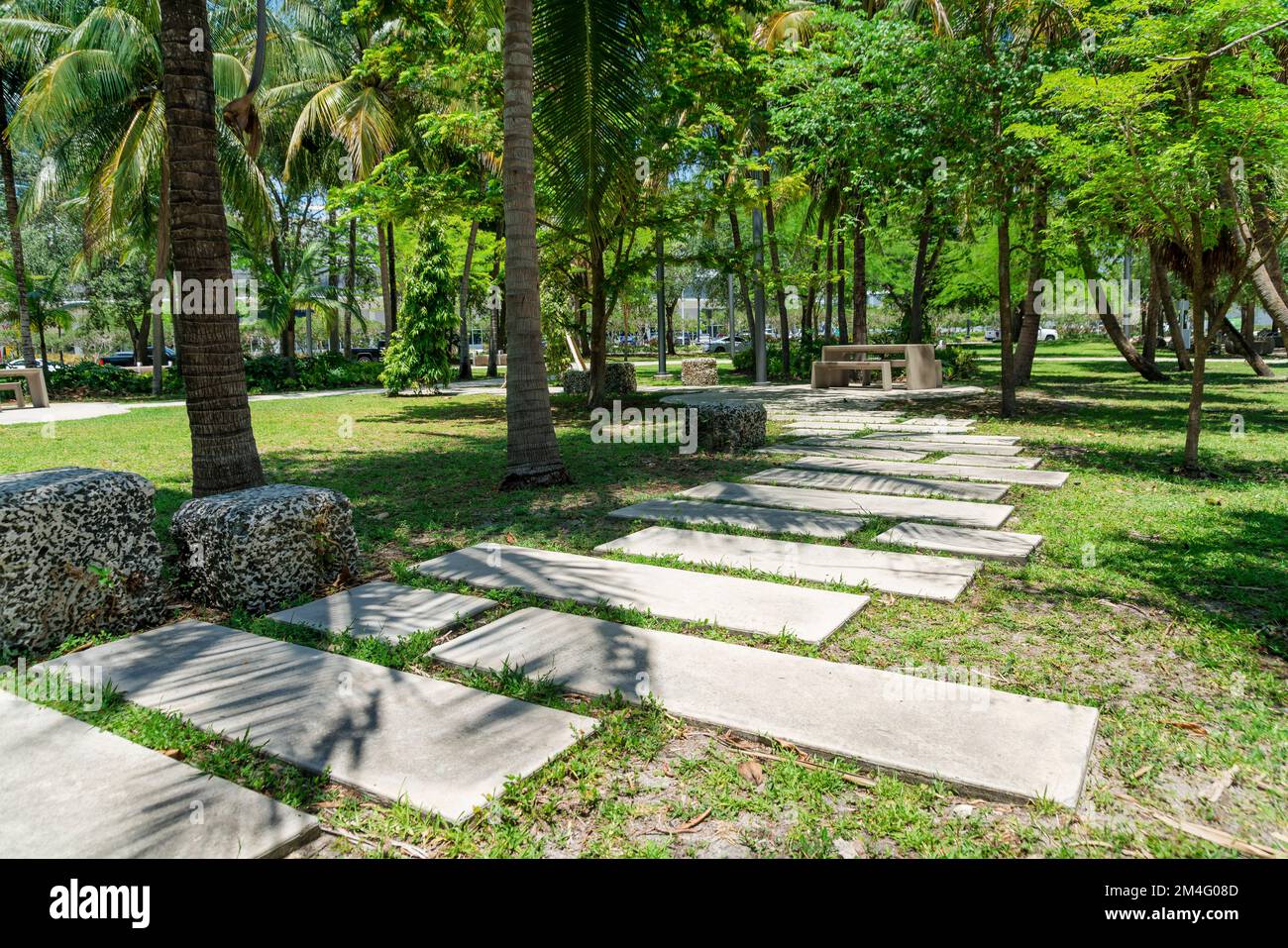 Concrete pavers on the grass in a park with picnic table and square ...