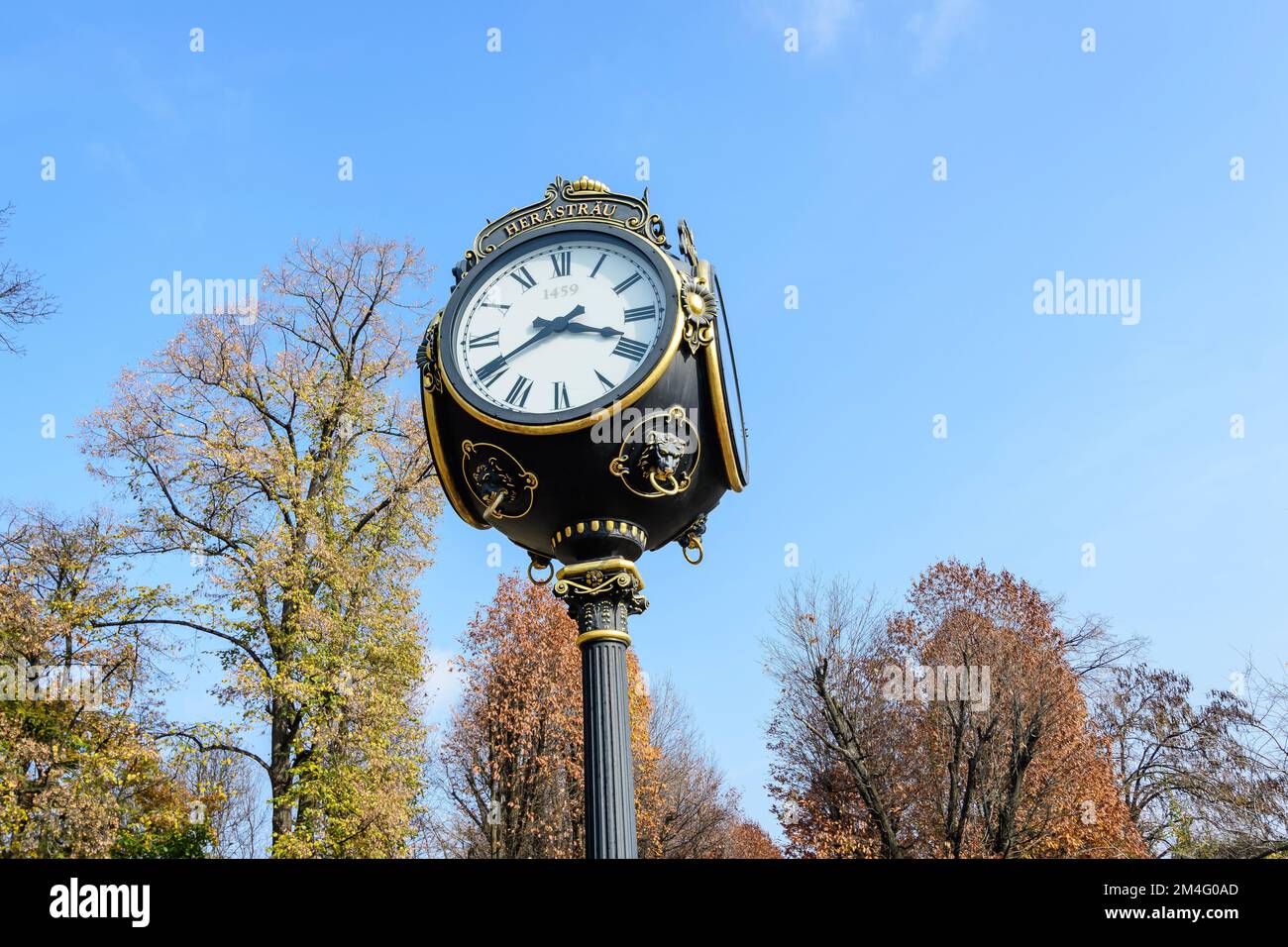 Vintage style black and grey metallic clock towards clear blue sky in ...