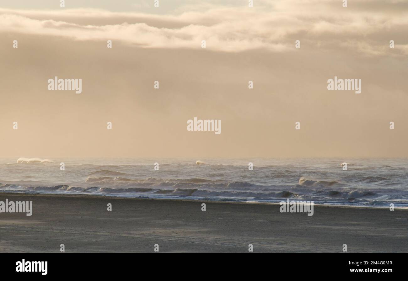 Sea and waves in golden, hazy light of sunset, low horizon Stock Photo ...